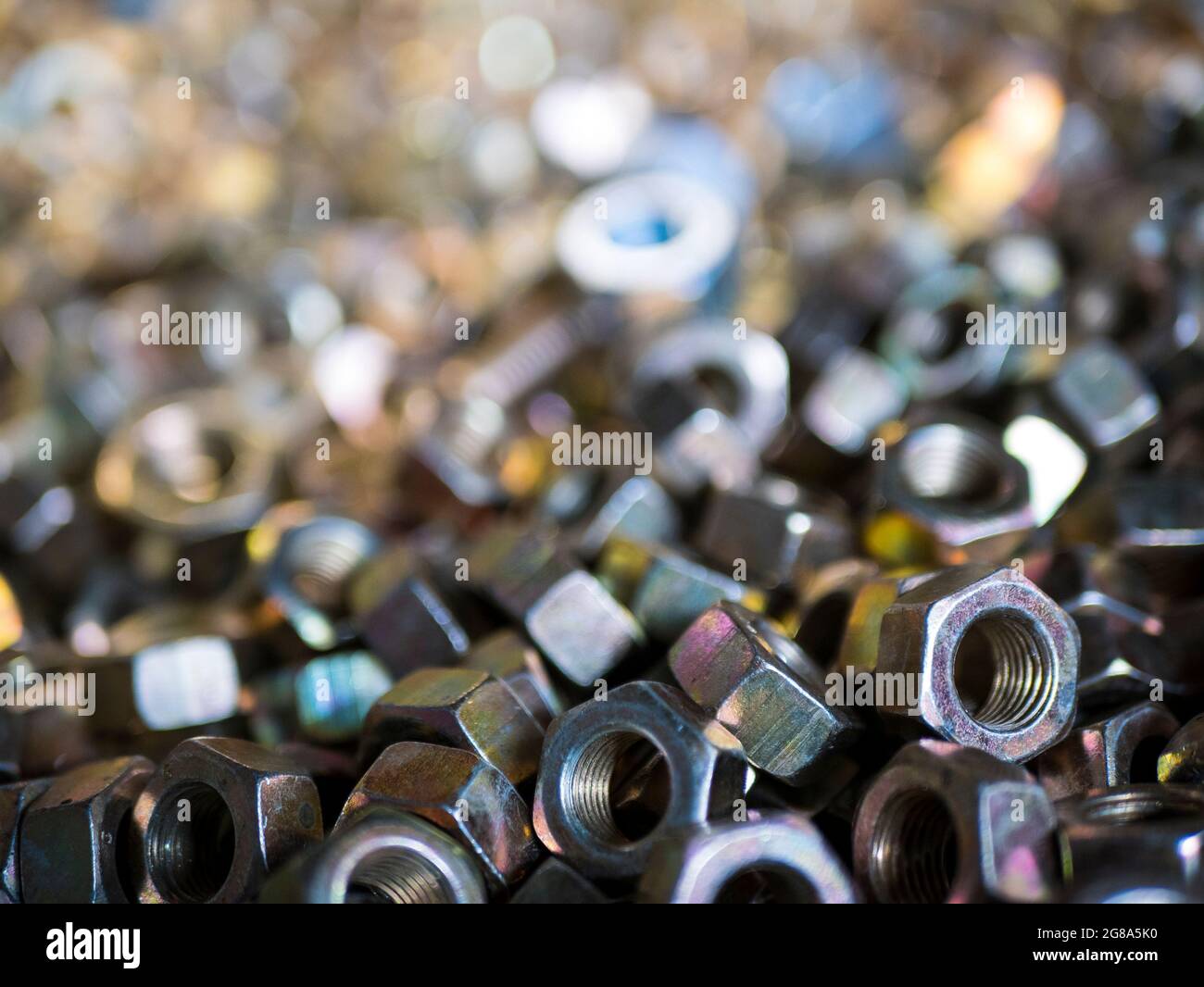 A lot of hexagonal nuts. Mechanical fasteners with a threaded hole ...