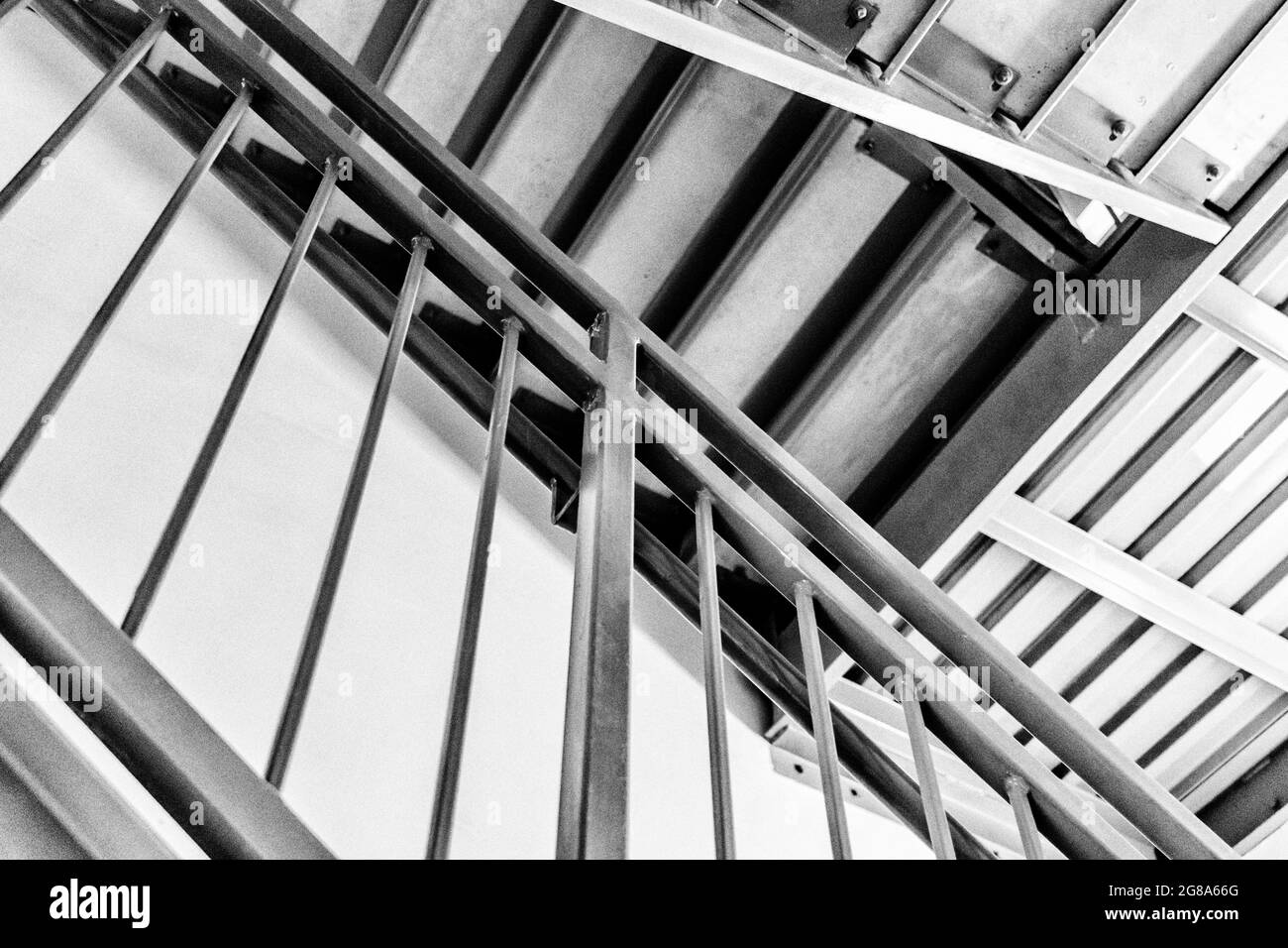 Railings and steps in a stair well create an abstract design Stock ...
