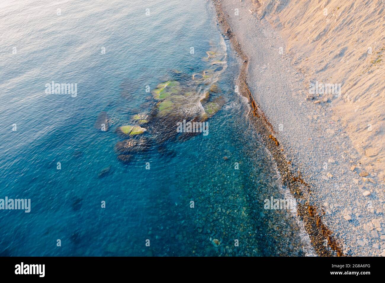 Aerial view of sea surface with stones and coastline Stock Photo - Alamy