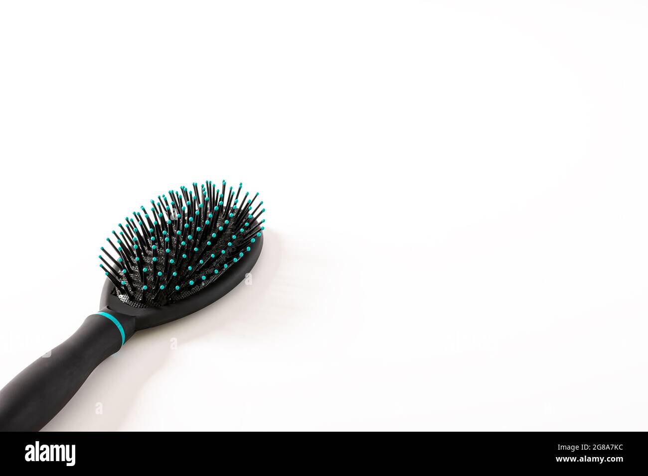 Minimalist photograph of a woman's hair brush.The photo is taken in the ...
