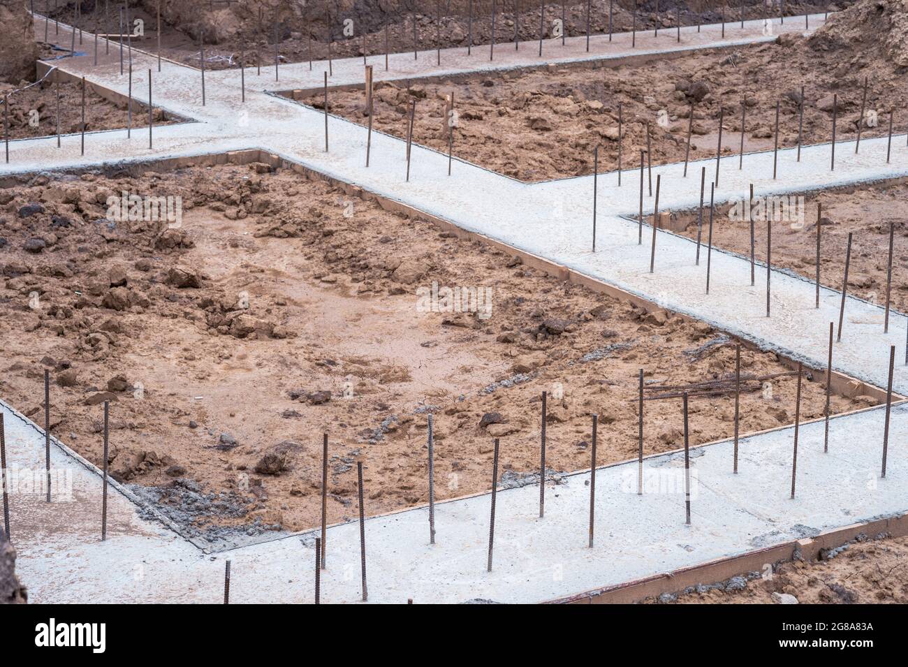 Pouring a concrete solution of the foundation of the construction of a ...