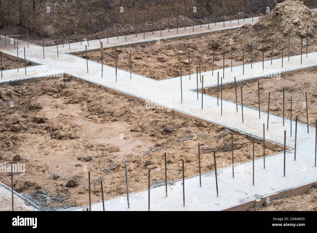 Pouring a concrete solution of the foundation of the construction of a ...