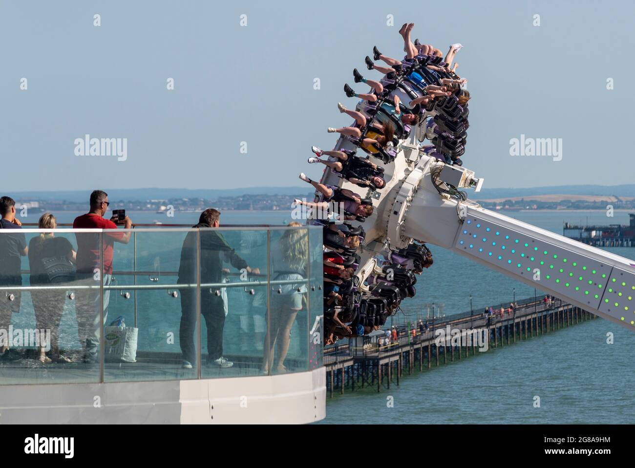 People on the viewing deck watching thrill riders on the Axis ride in ...