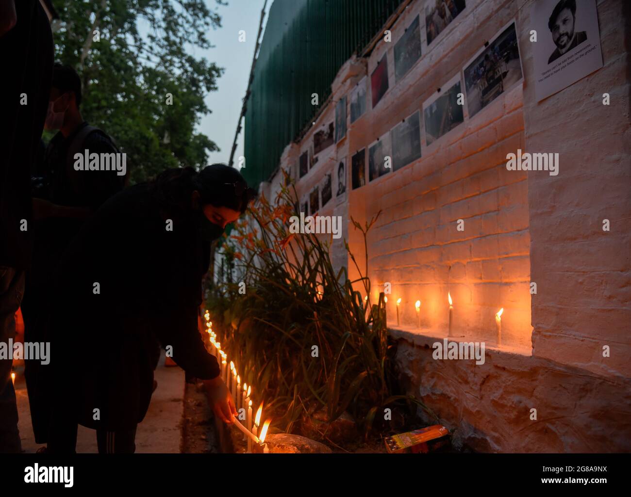A journalist lights candles during a candle light vigil in remembrance ...