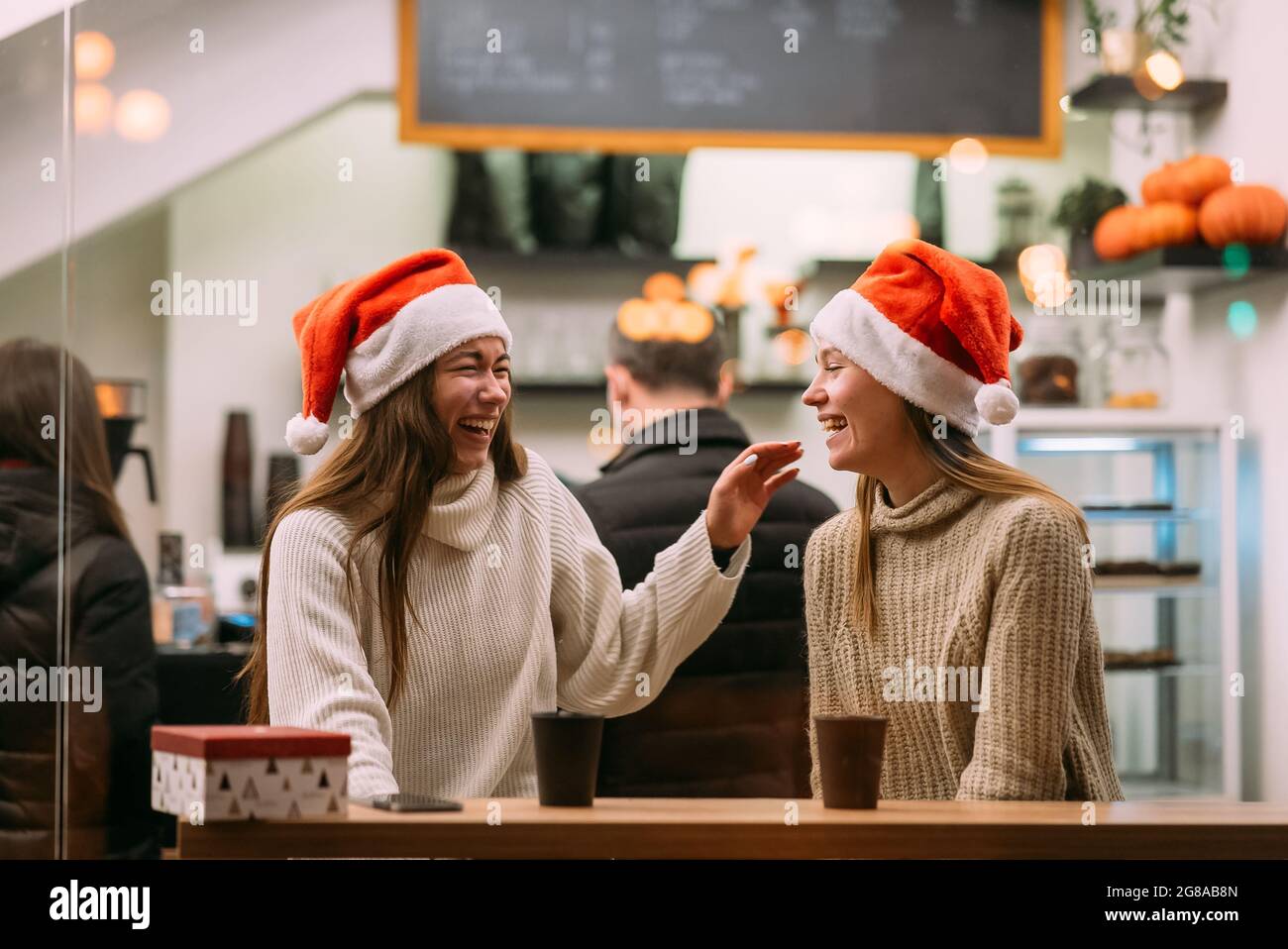 Portrait of happy cute young friends having fun in cafe Stock Photo - Alamy