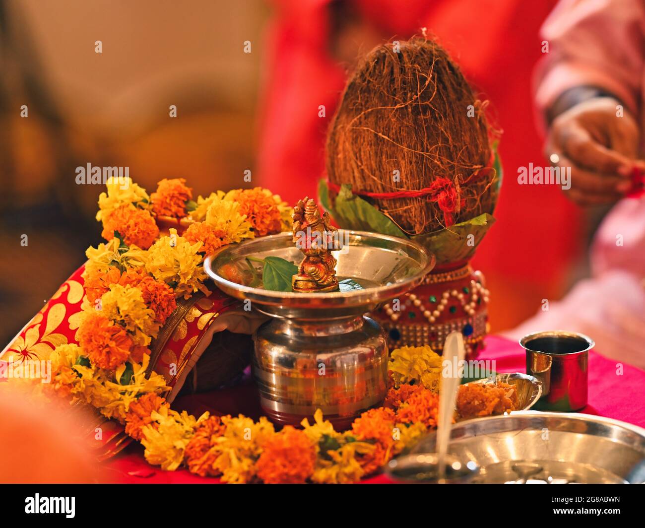 A closeup of vibrant Indian wedding ritual with various decorations and ...