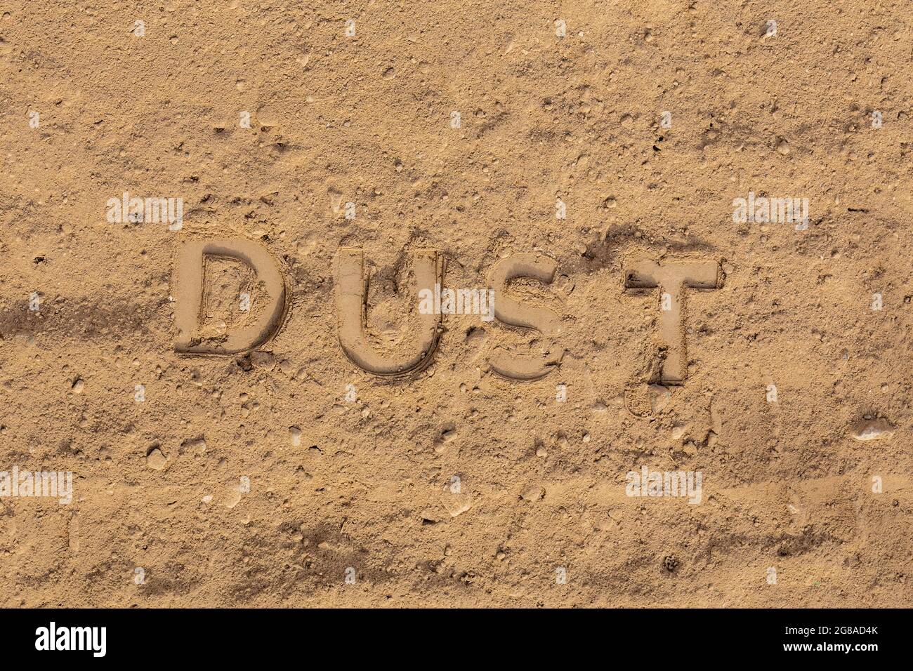the word dust embossed on dusty road surface in flat lay perspective ...