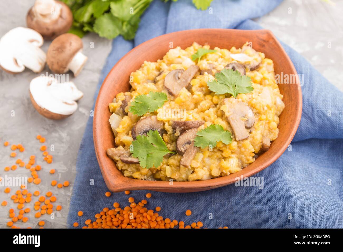 Lentils porridge with champignons and coriander in a clay bowl on a ...