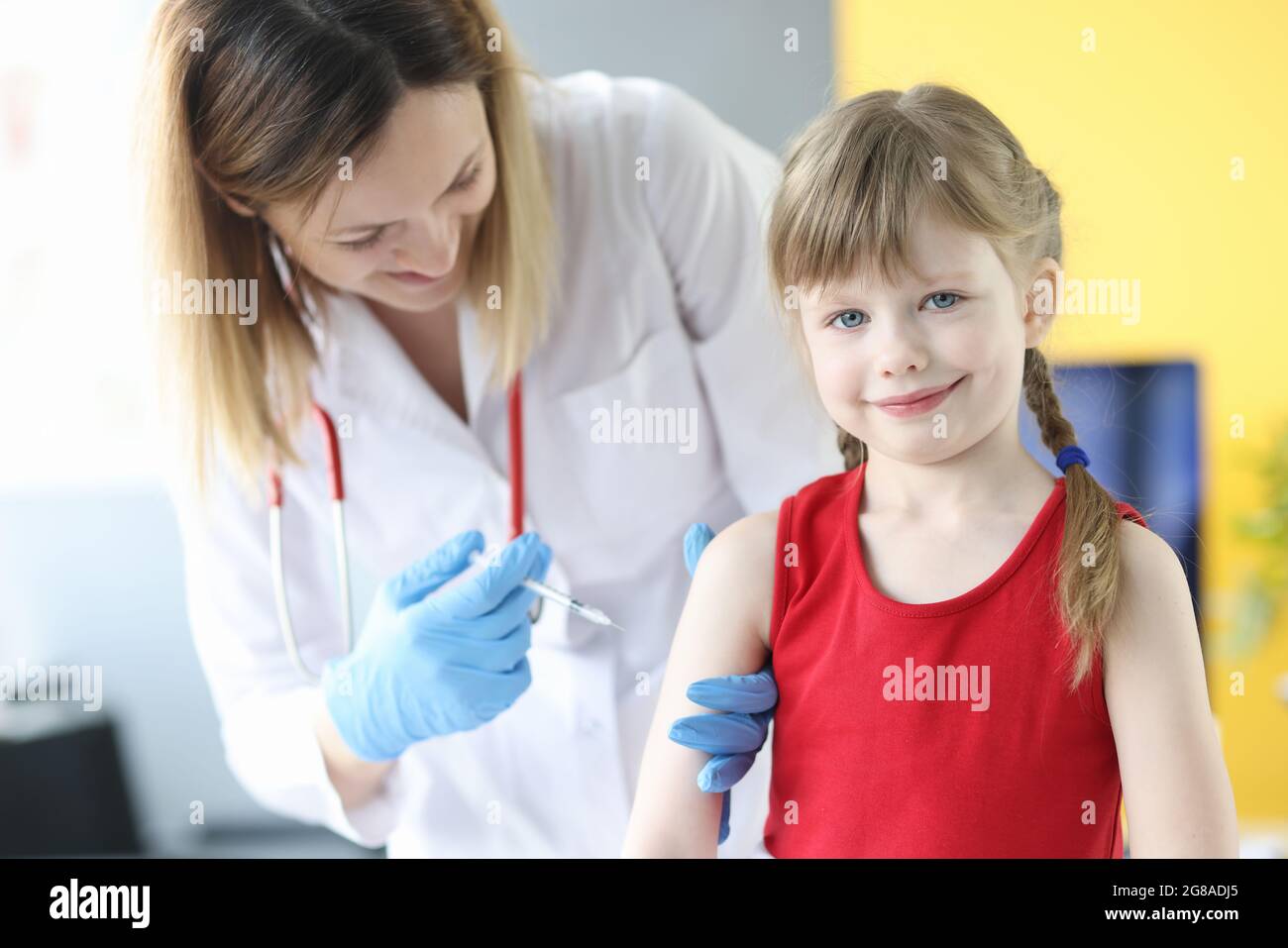 Doctor injects little girl in shoulder. Vaccination development of ...