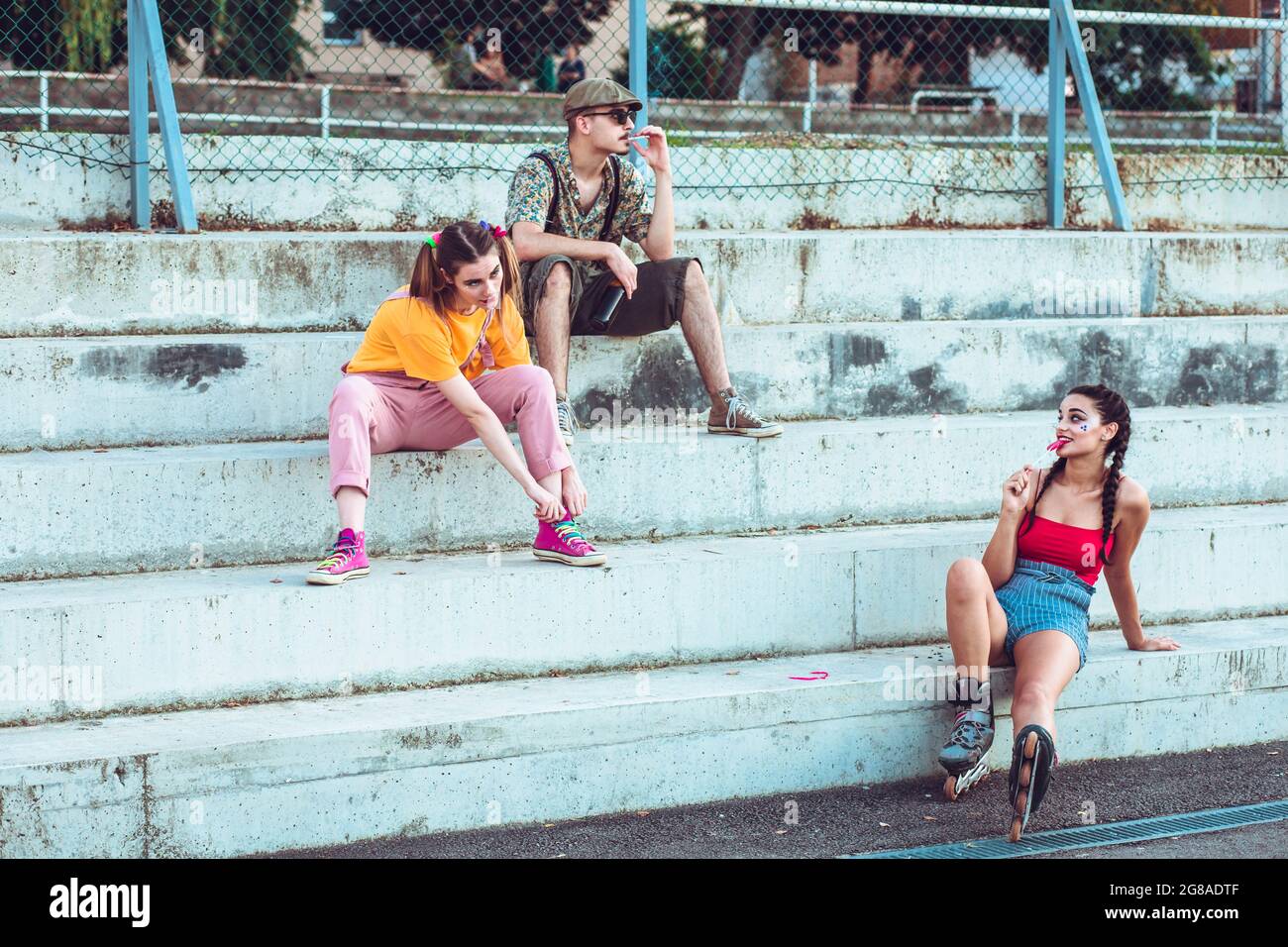 Group of friends hanging out outside. Chilling Stock Photo - Alamy