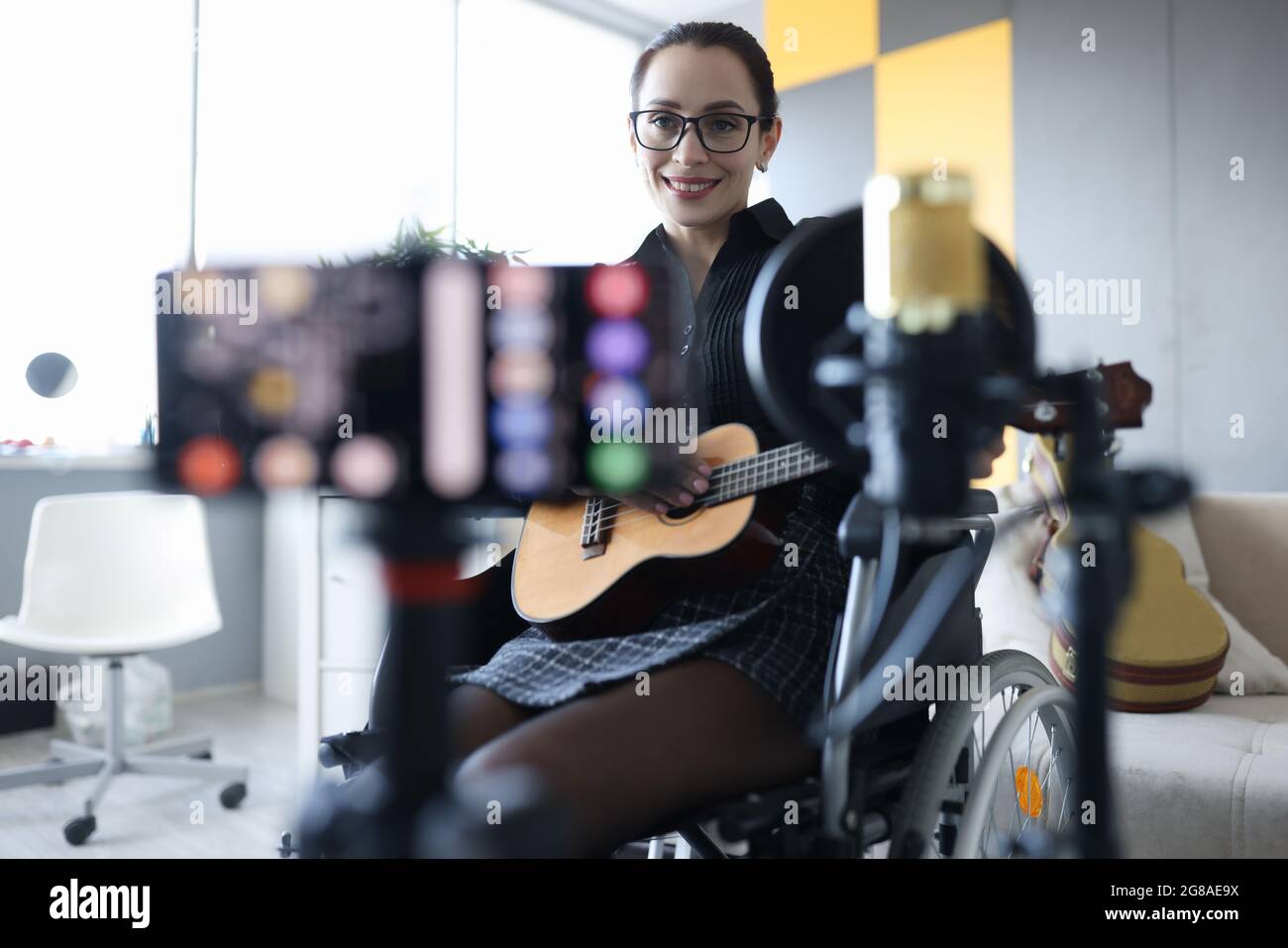 Smiling learning to play a guitar hi-res stock photography and images ...