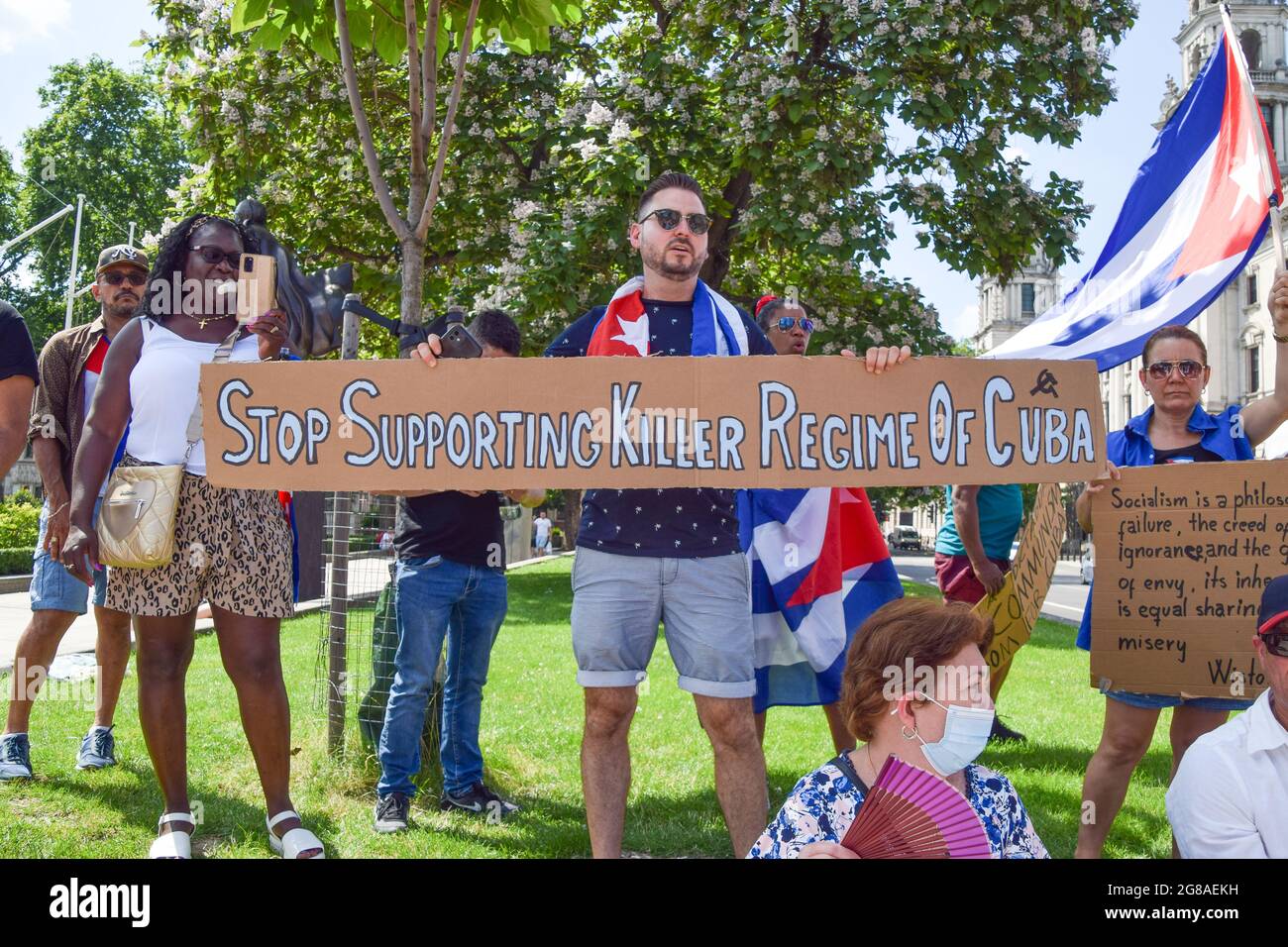 A protester holds an anti-government placard during the SOS Cuba ...