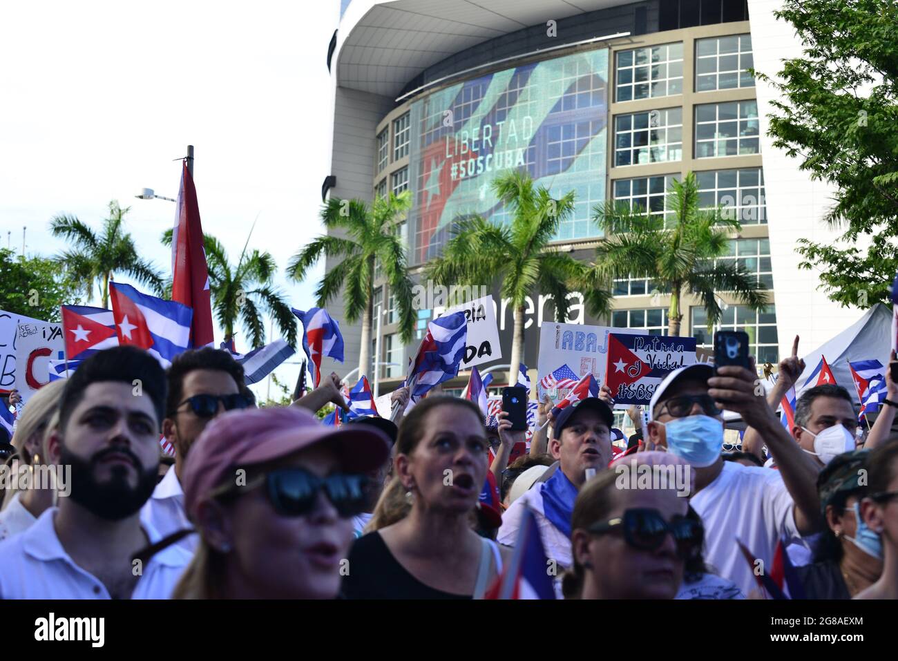 MIAMI, FLORIDA - JULY 17: People wave Cuban and US flags during a ...