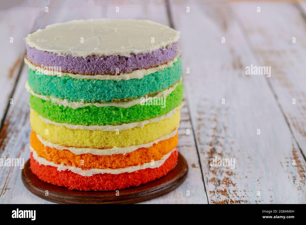 Six color layer of cake with white cream. Close up Stock Photo - Alamy