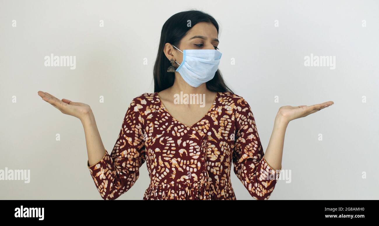 A closeup shot of a confused Indian girl wearing a face mask- new ...