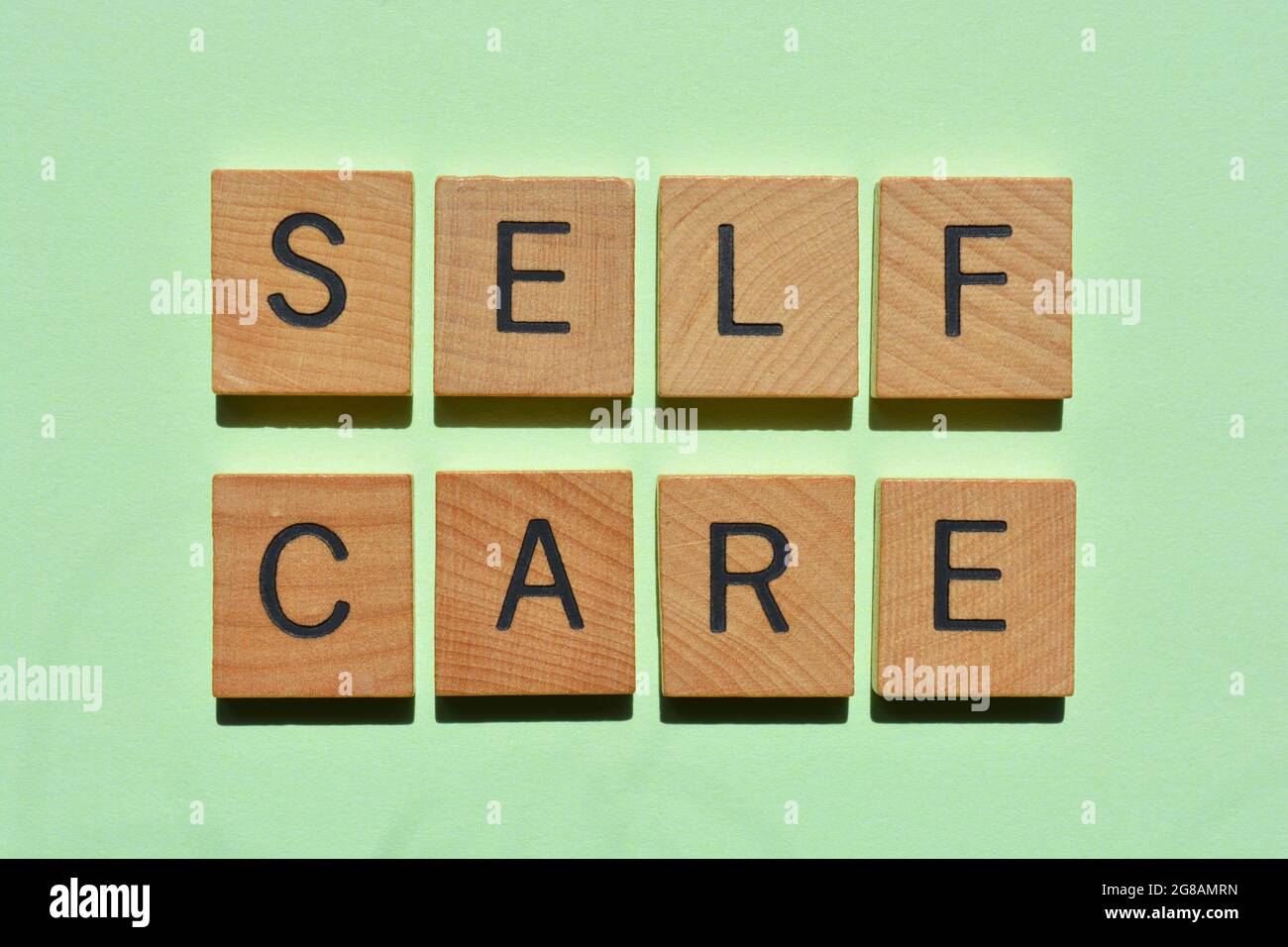 Self Care, words in wooden alphabet letters isolated on green ...