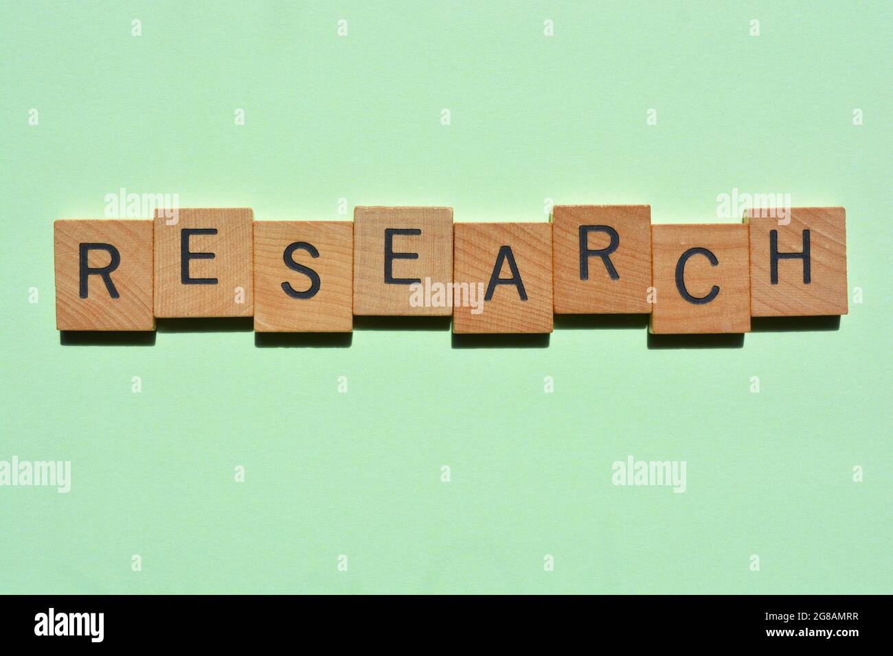 Research, word in wooden alphabet letters isolated on green background ...