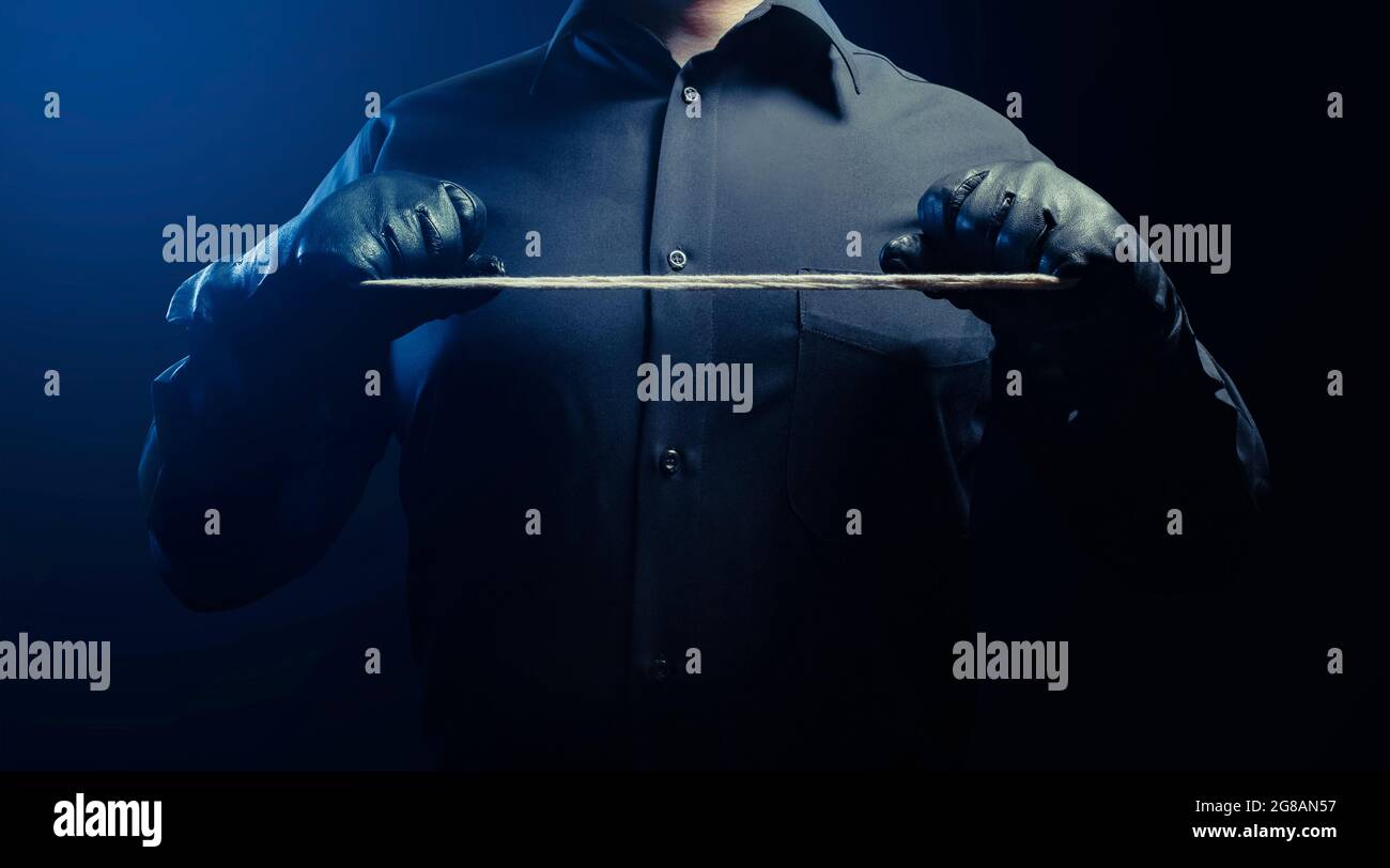 Photo of a shaded strangler assassin man in black shirt and leather ...