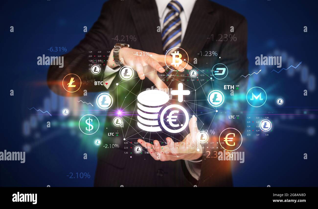 Businessman holding currency symbols concept Stock Photo - Alamy