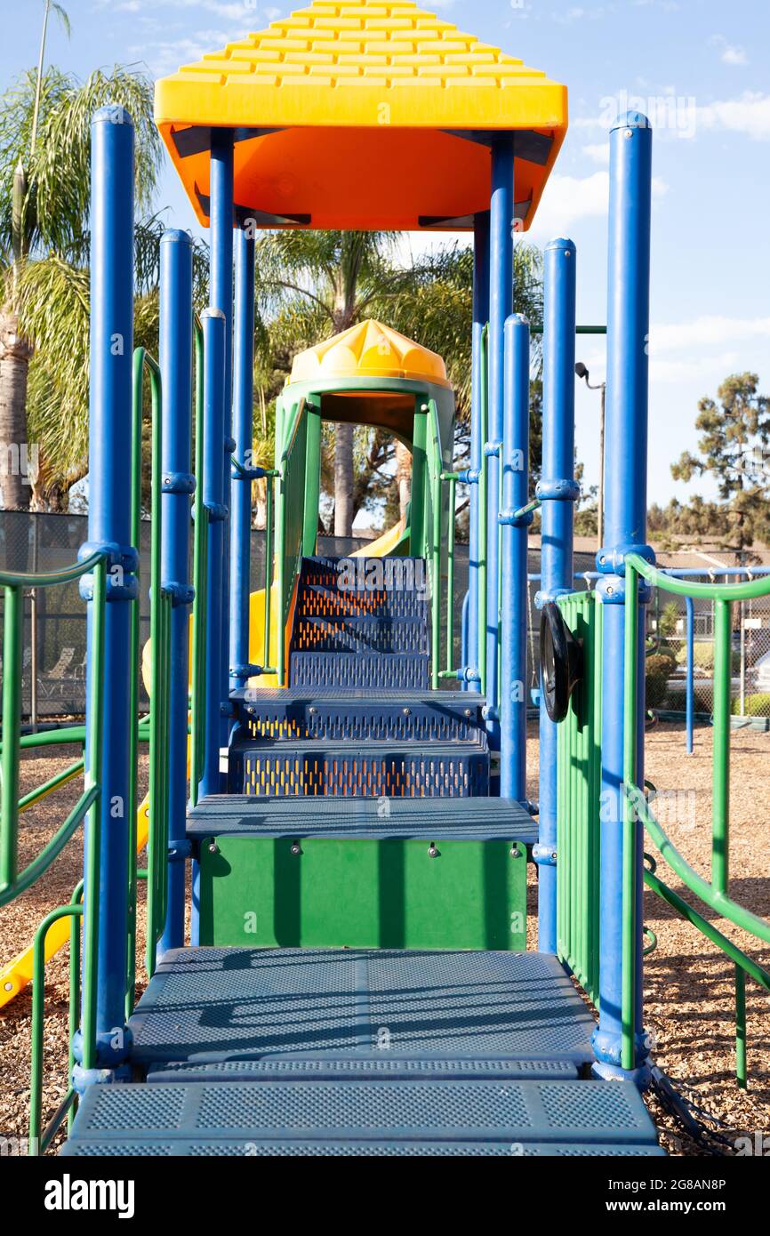Modern colorful kids playground - swings, slides, steps and ladders ...