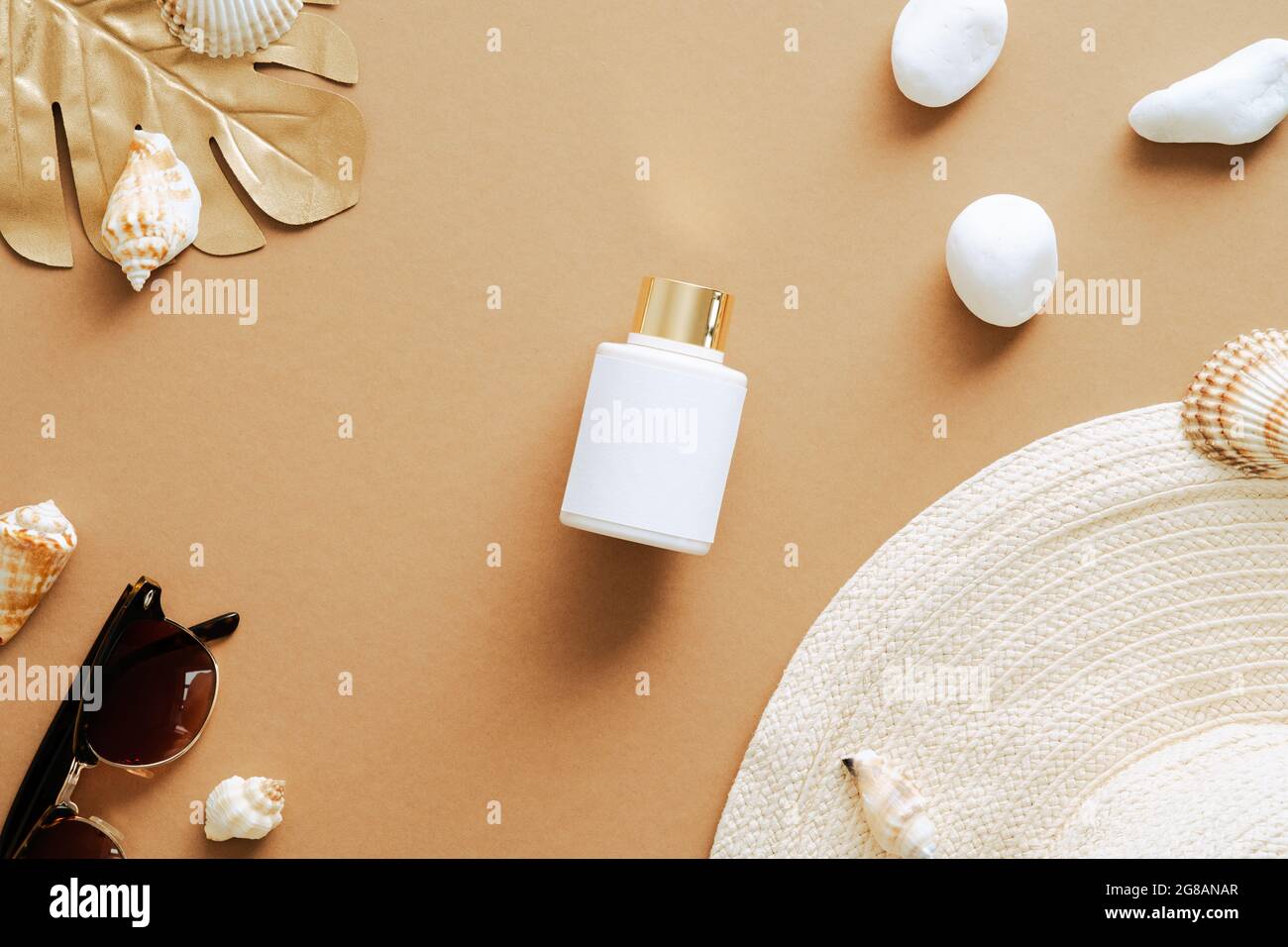 Flat lay composition with sunscreen lotion, straw hat, seashells ...