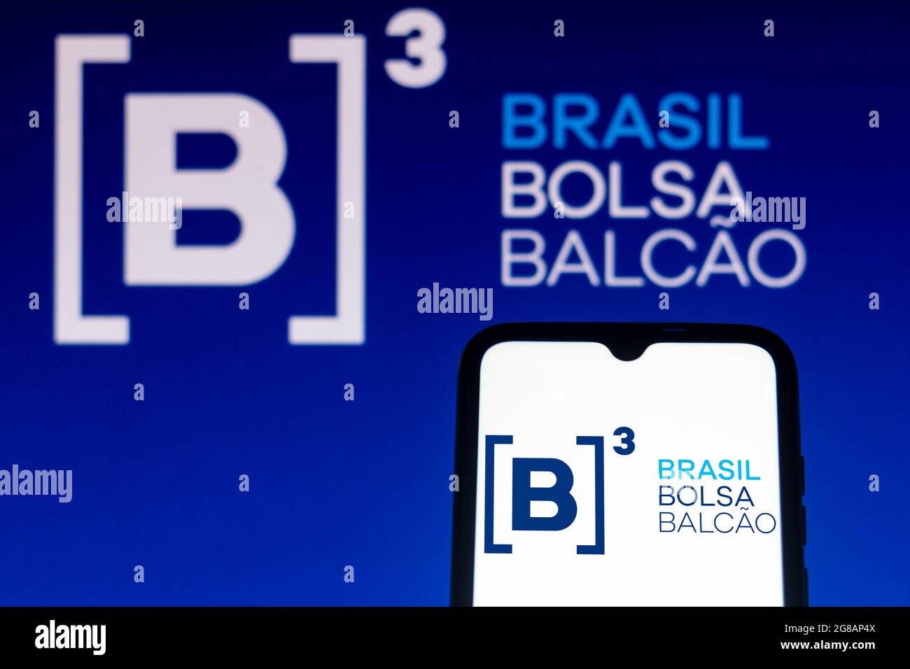 In this photo illustration the B3 logo is seen on a smartphone and a pc ...