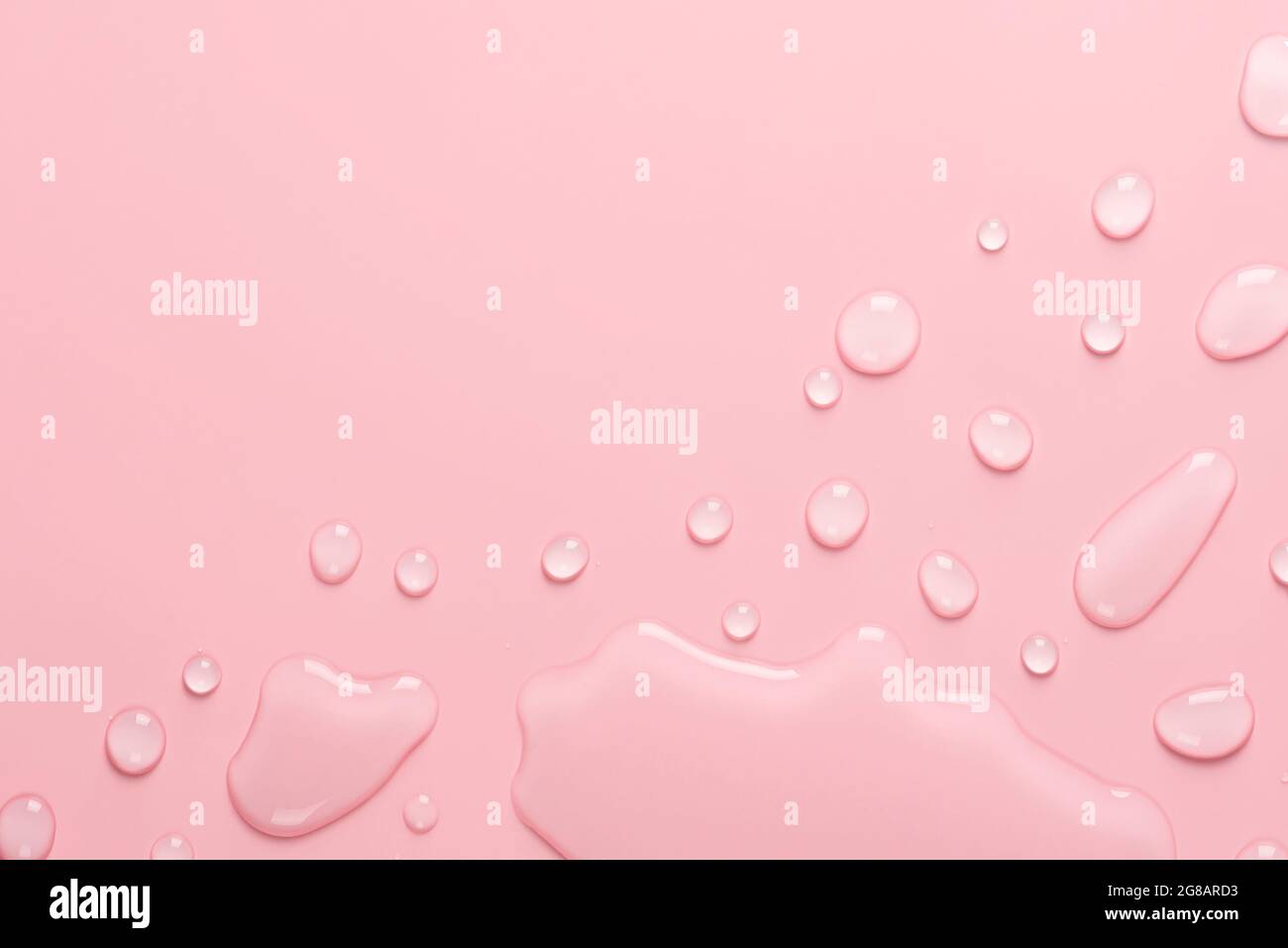 Splash of Water and drops on a pastel pink background. Water texture ...