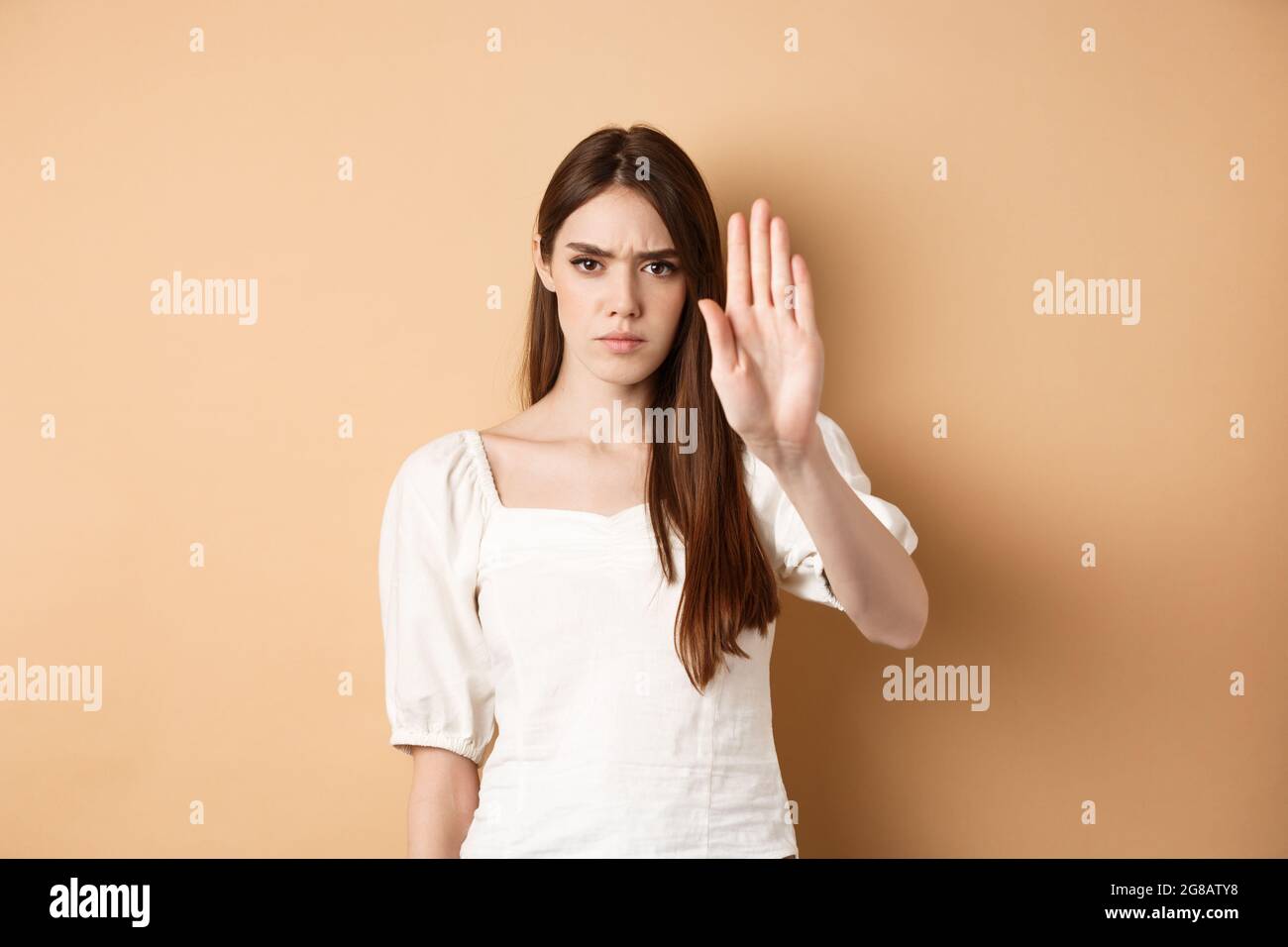 Nope stop right there. Serious and confident woman stretch out hand to ...