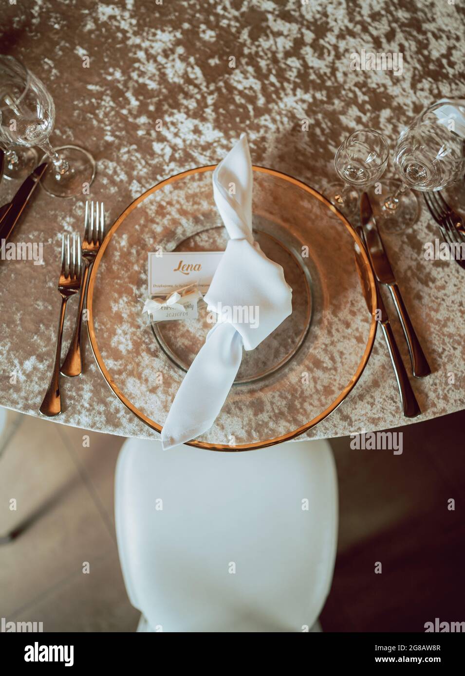 Vertical top view of an empty glass plate with a white ribbon on an ...
