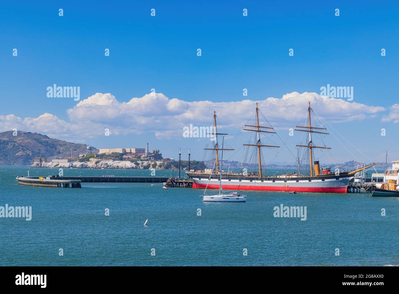 Sunny view of the Alcatraz Island and San Francisco Bay with a vessel ...