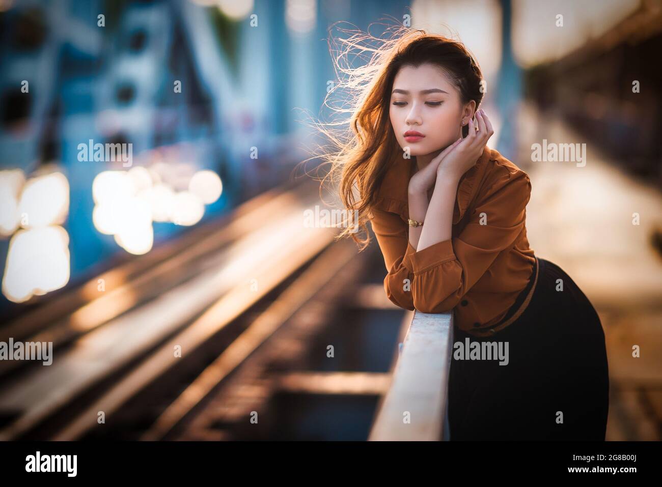A beautiful woman with straight hair on the train track Stock Photo - Alamy