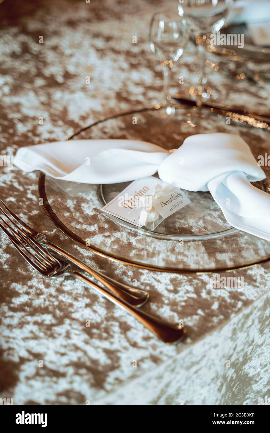 Vertical selective focus shot of an empty glass plate in a restaurant ...
