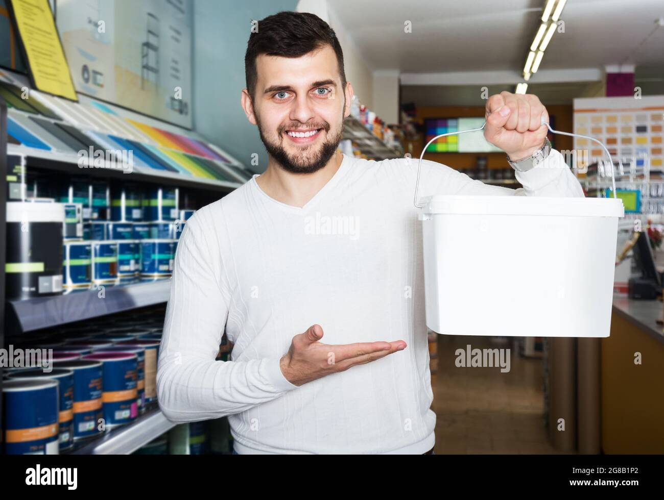 Man choosing wall paint Stock Photo - Alamy