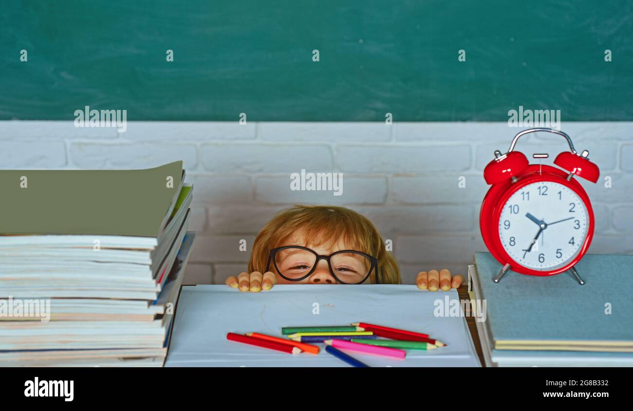 Time to learn concept. School kids against green chalkboard. Learning ...