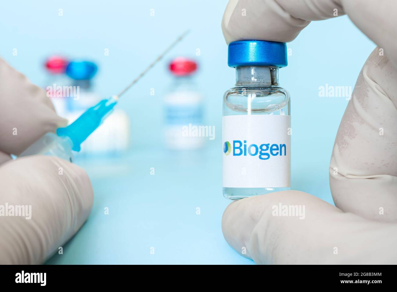 Vials of liquid on a white table and the logo Biogen, large ...