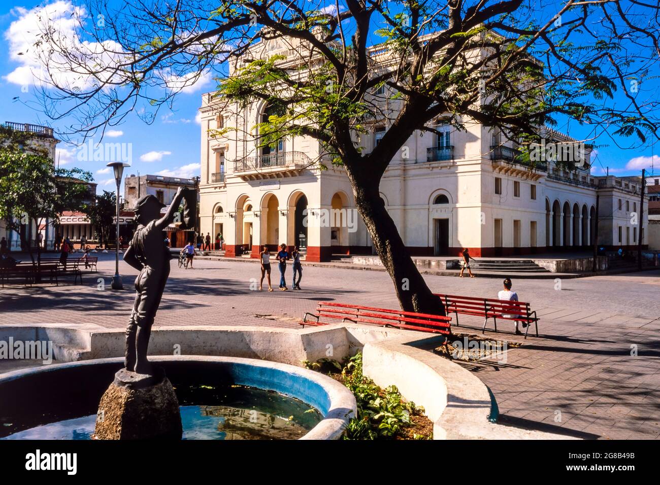 People walking past Teatro La Caridad, Parque Vidal, Santa Clara, Cuba ...