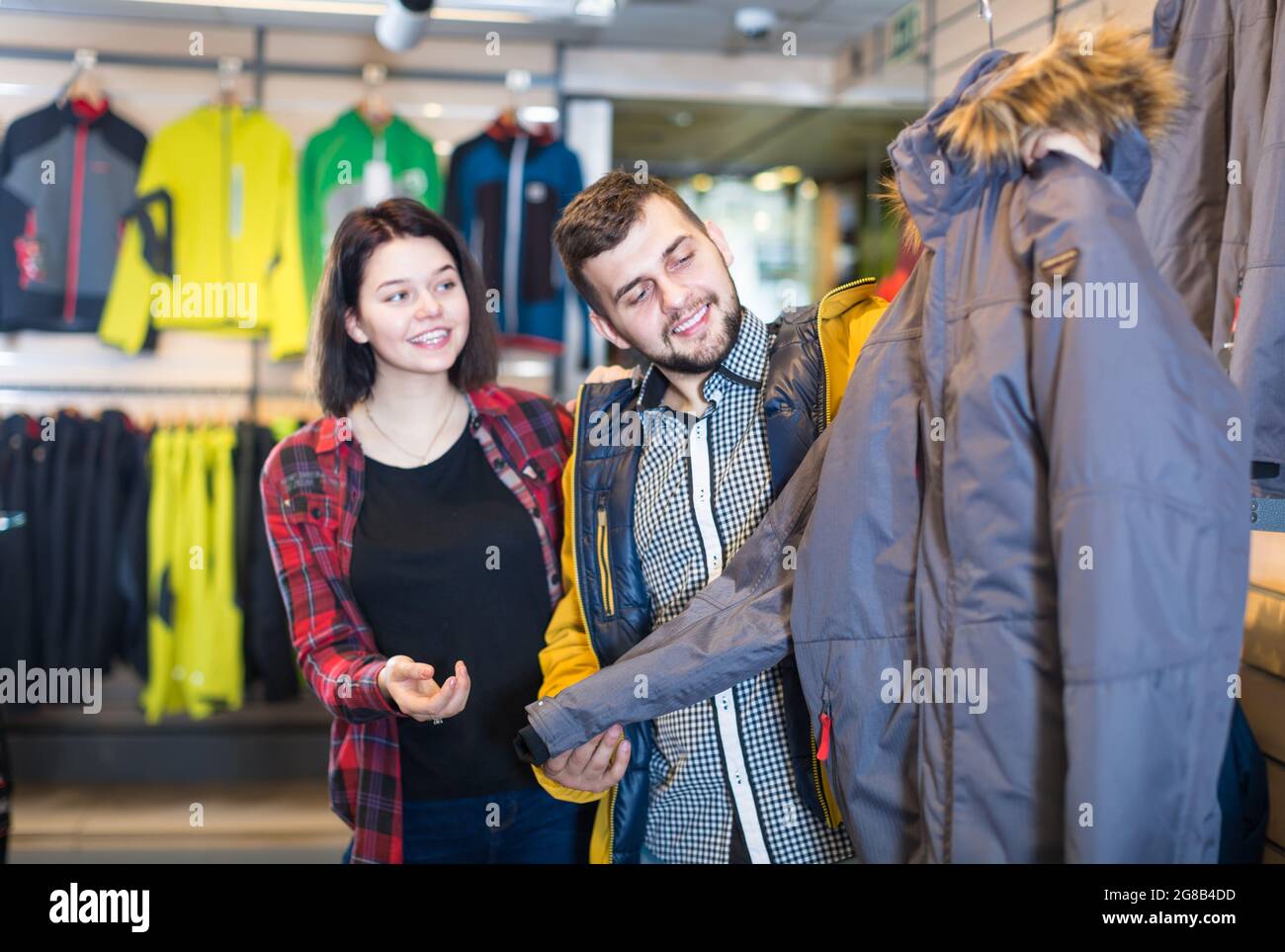 Couple chooses a stylish winter jacket Stock Photo - Alamy