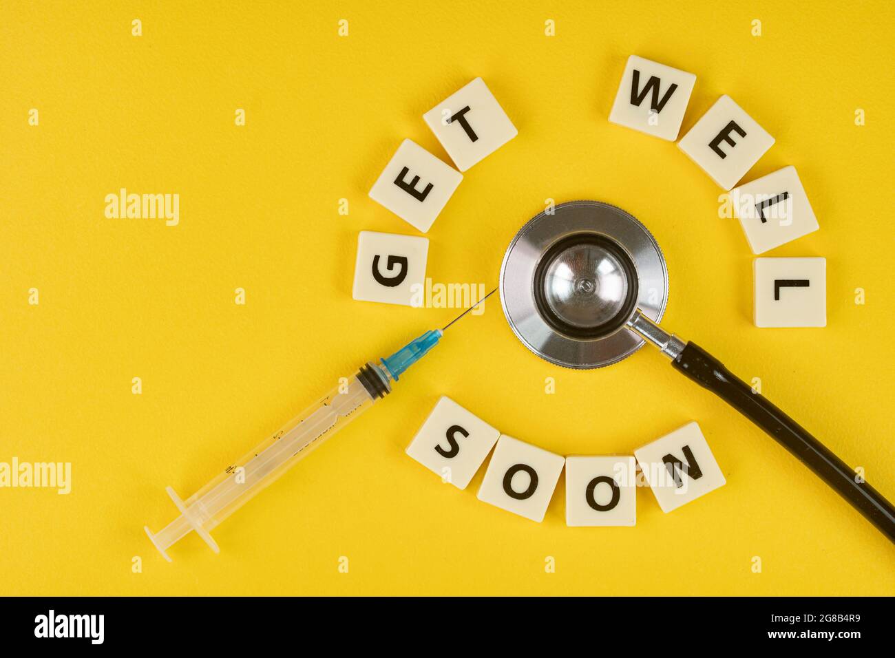 Medical concept. Layout of alphabet blocks, a syringe and a stethoscope ...