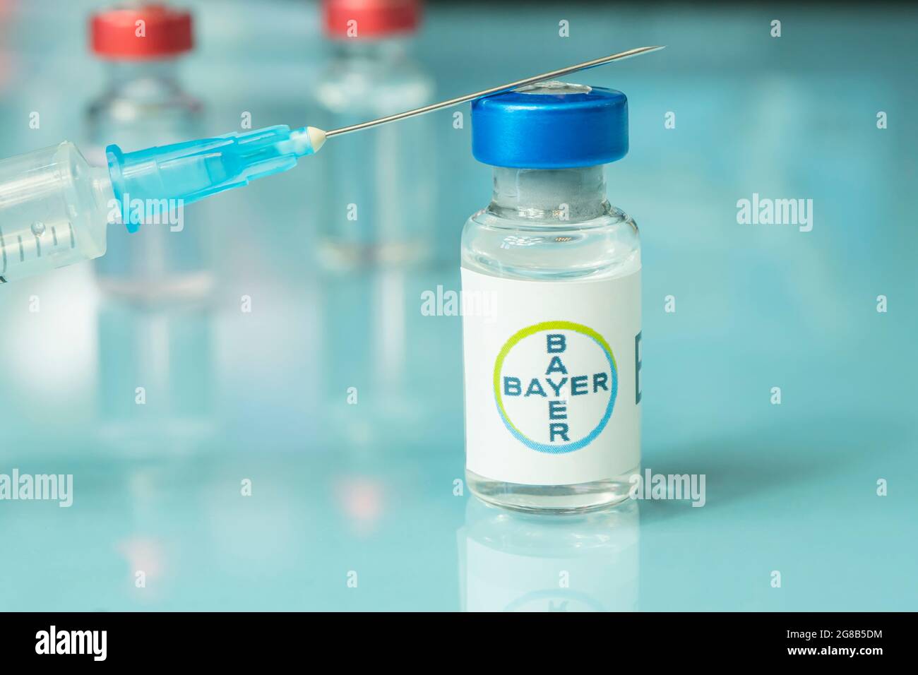 Vials of liquid on a white table and the logo Bayer, large ...