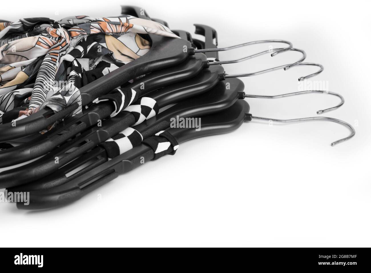 Stack of dresses on hangers on a white Stock Photo - Alamy