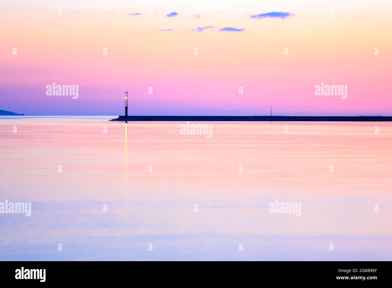 A Concrete Breakwater On A Horizon A Beautiful Seascape A Purple Sky And Reflection In The