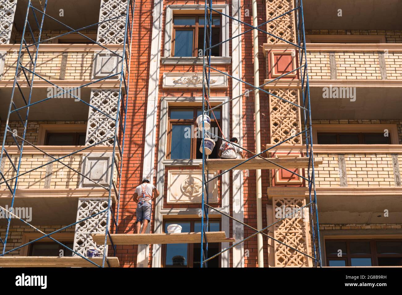 Finishing works on the facade of a new residential buildings Stock ...