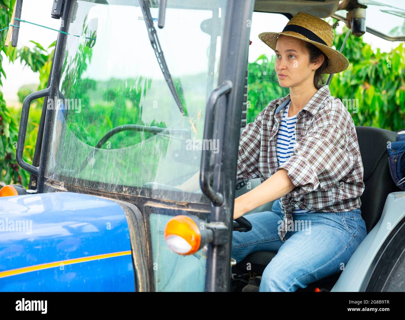 Woman driving tractor field hi-res stock photography and images - Alamy