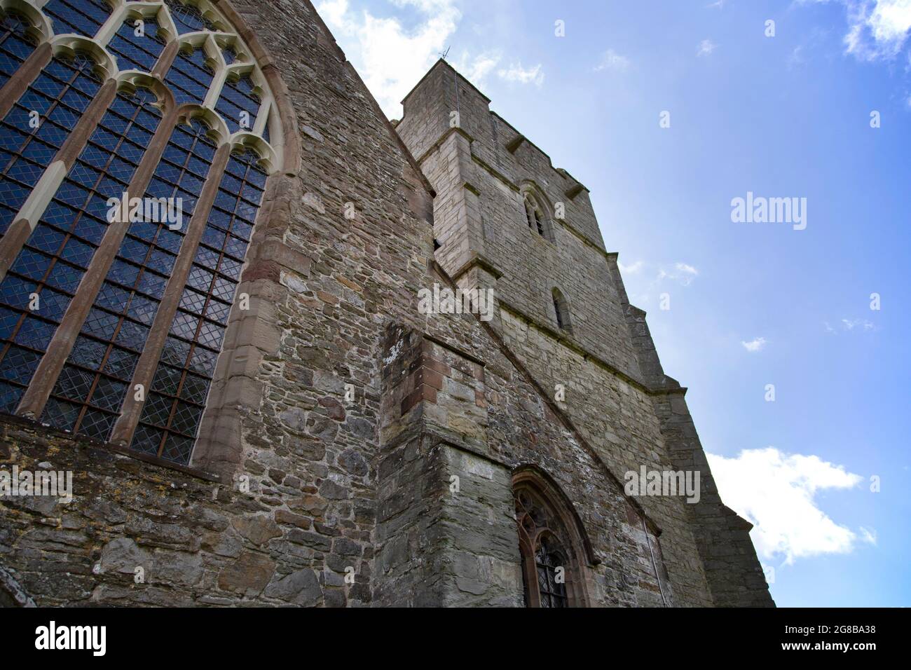 Presteigne church window and tower in Powys, Wales. With a blue sky ...