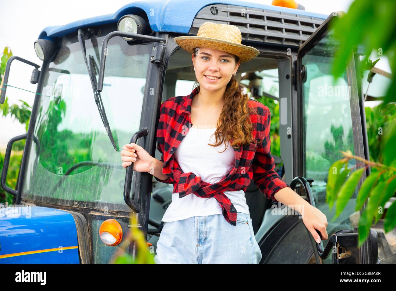 Portrait of female worker working on tractor Stock Photo - Alamy