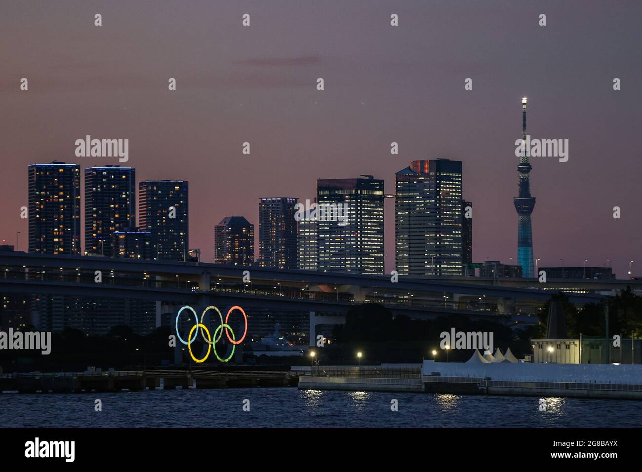 A large monument of the Olympic rings is displayed before the Tokyo ...