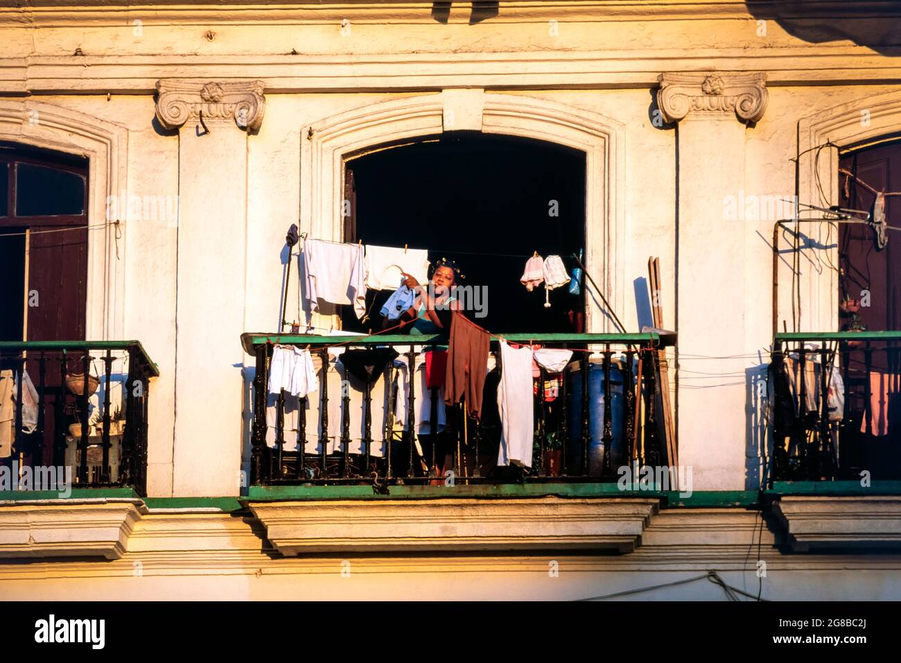 Cuban woman hanging out laundry on balcony, Havana, Cuba Stock Photo ...