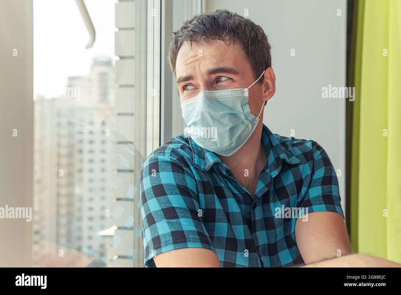 Sad man looks outside window hi-res stock photography and images - Alamy