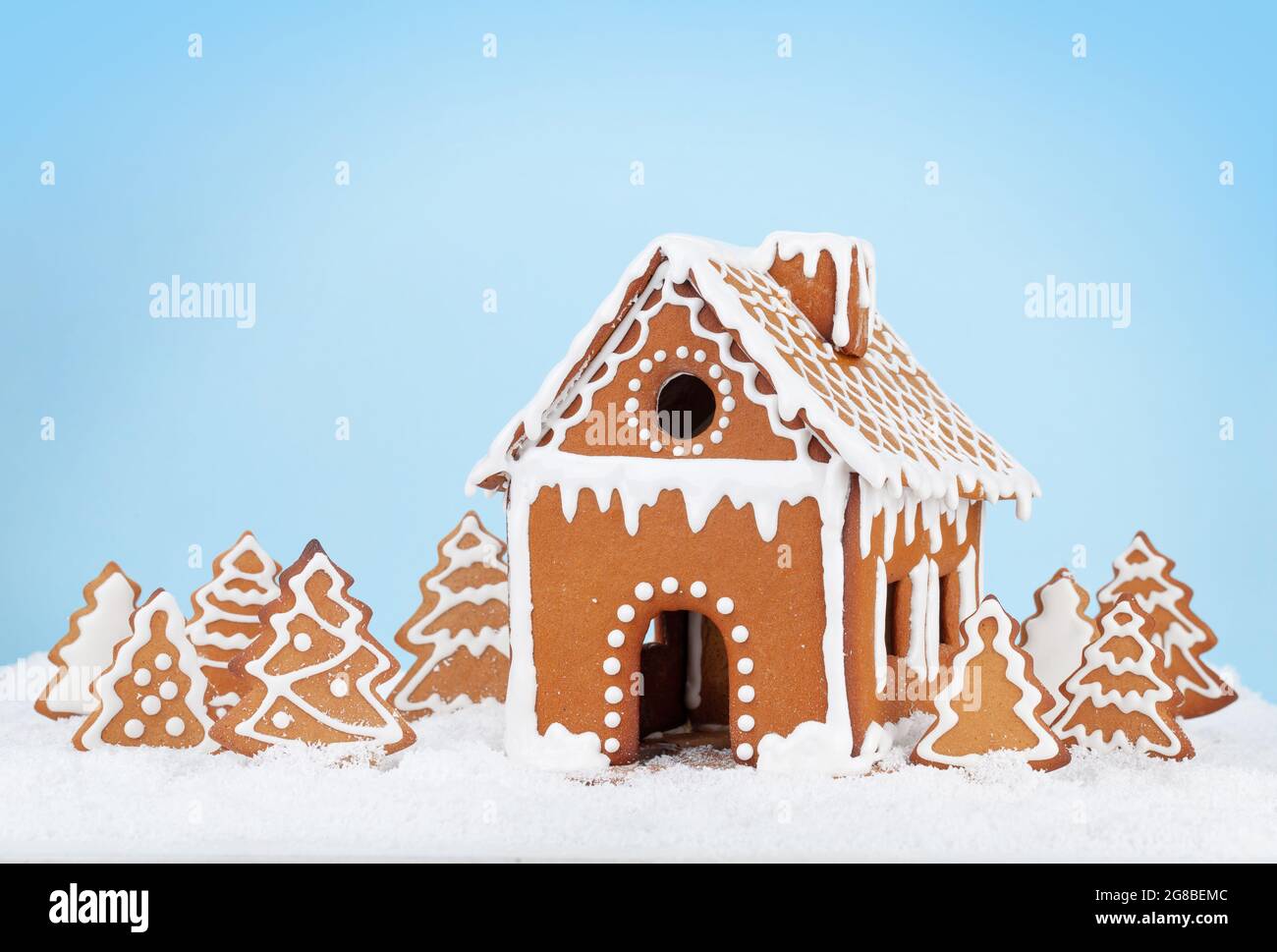 Christmas greeting card with gingerbread house, gingerbread fir trees ...