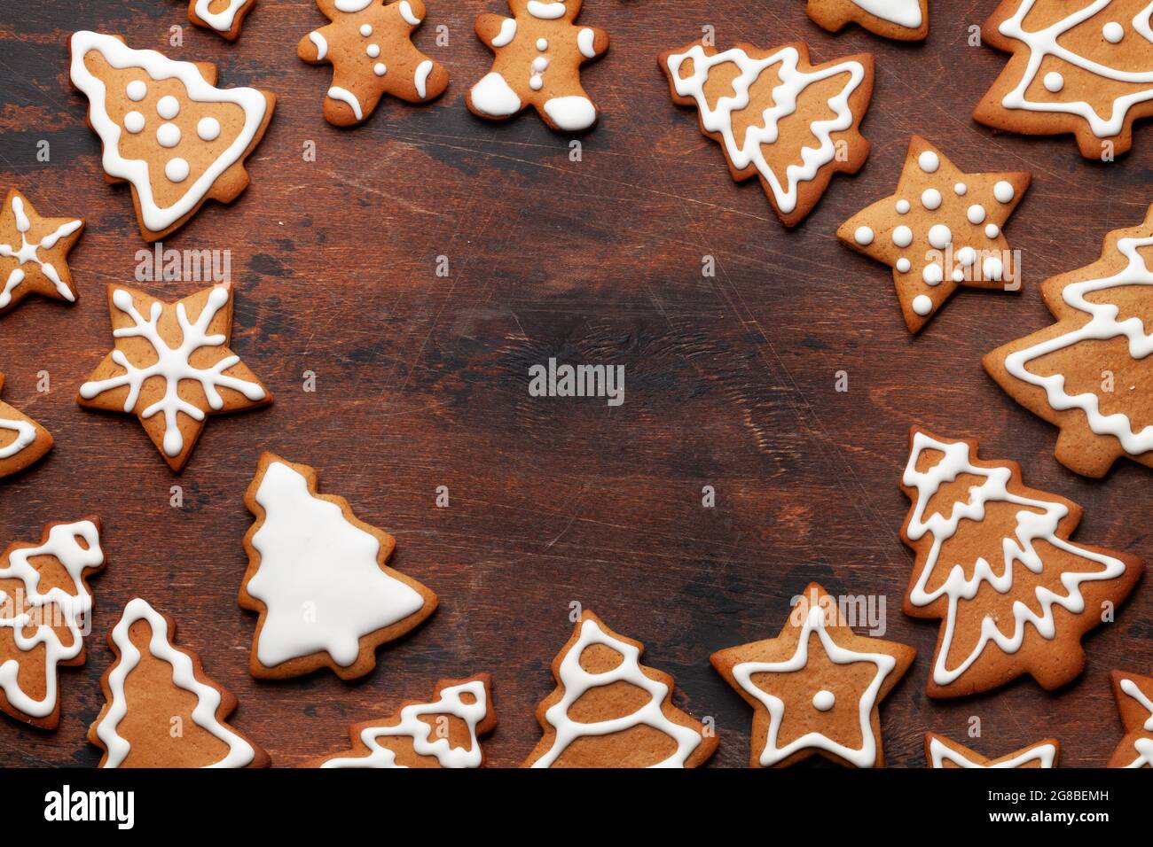 Christmas card with gingerbread cookies over wooden background. Top ...